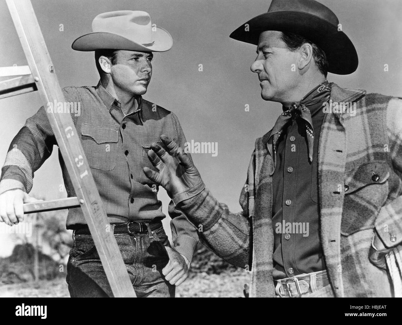 BLACK HORSE CANYON, from left: Audie Murphy visiting Joel McCrea, on set, 1954 Stock Photo - Alamy