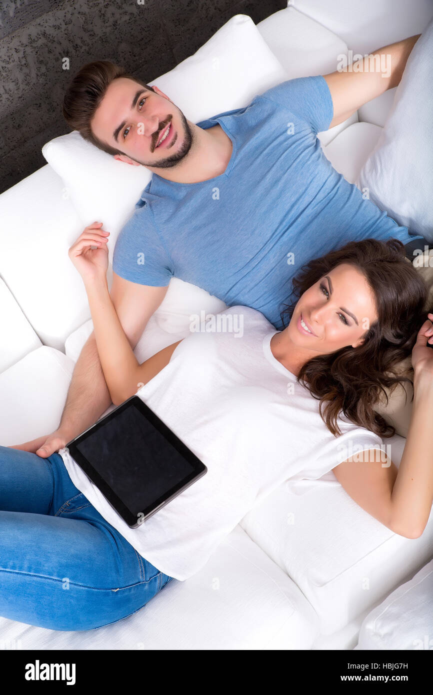 Young couple relaxing on the sofa Stock Photo - Alamy