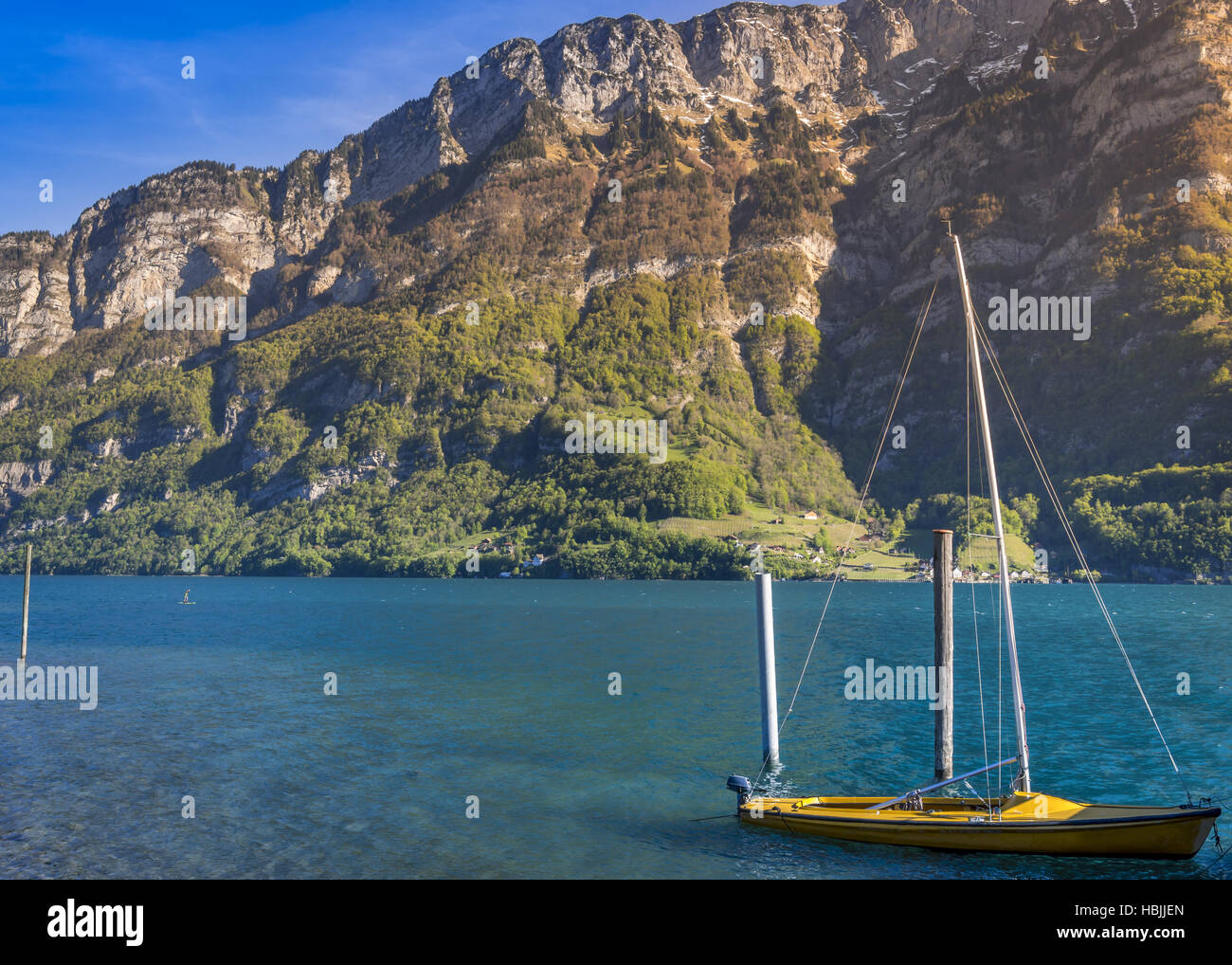 Boat with sails anchored on Walensee lake Stock Photo - Alamy