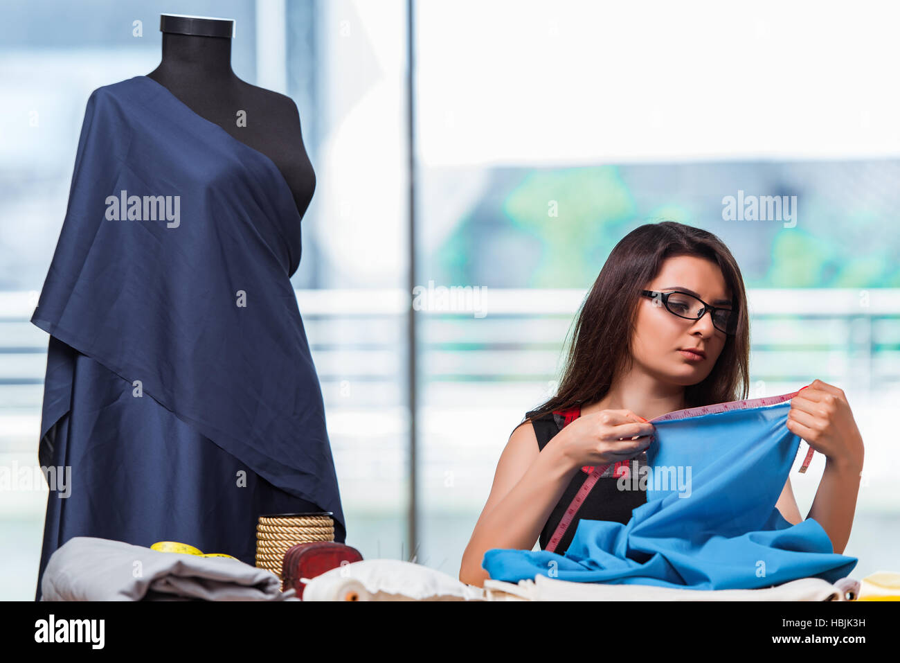 Woman tailor working on new clothing Stock Photo - Alamy