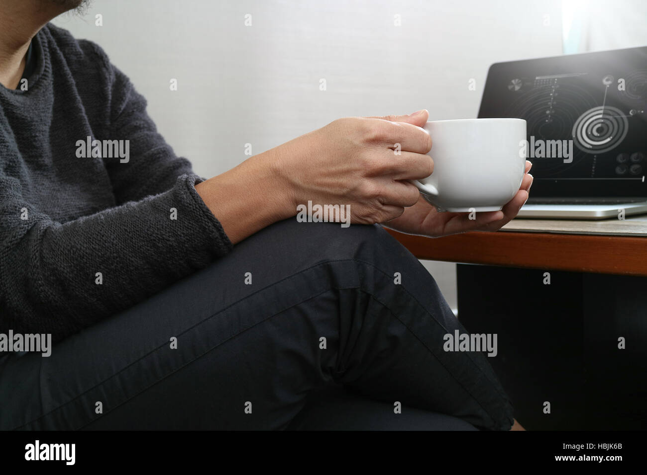 success businessman hand using smart phone,digital tablet docking smart keyboard,coffee cup on ...