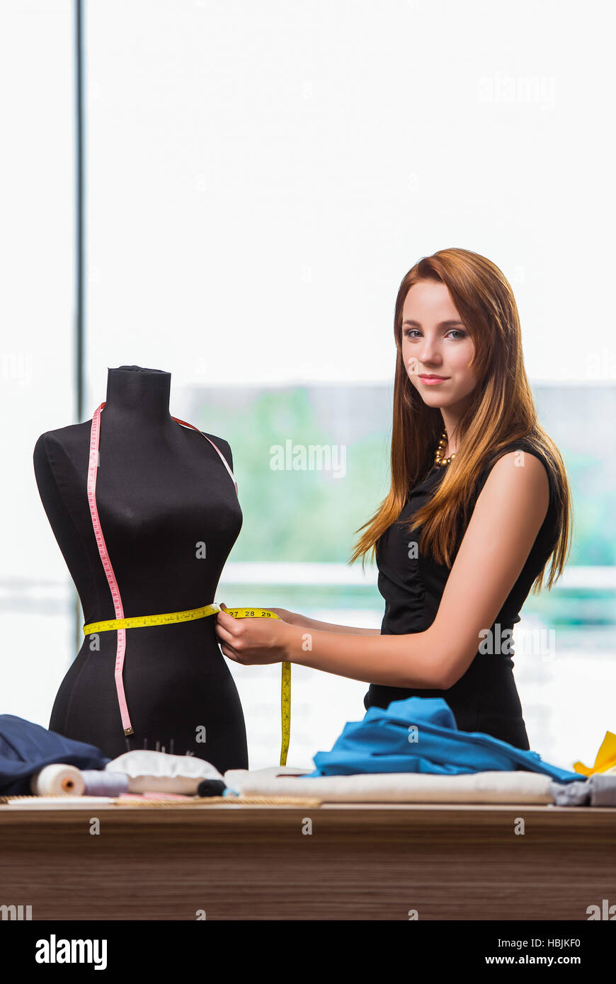 Woman tailor working on new clothing Stock Photo - Alamy