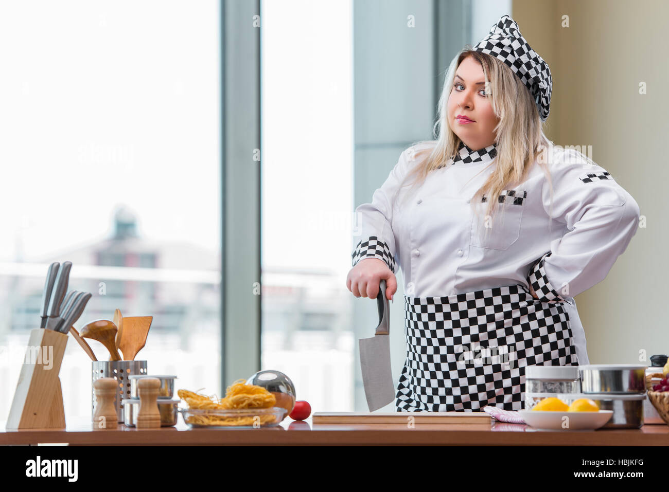 Young chef cook working in the kitchen Stock Photo - Alamy