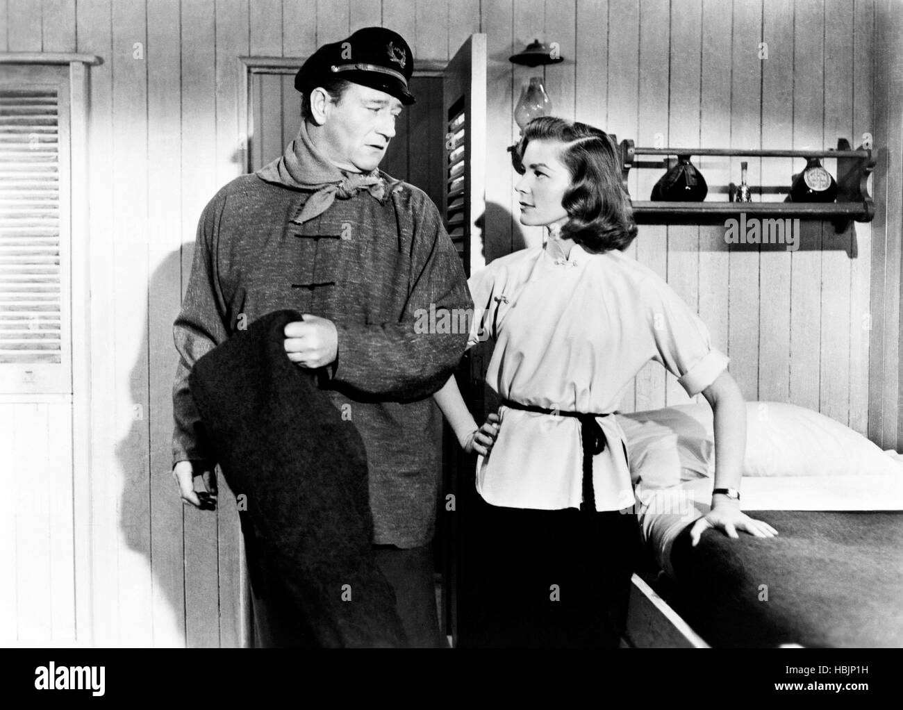 BLOOD ALLEY, from left: John Wayne, Lauren Bacall, 1955 Stock Photo - Alamy