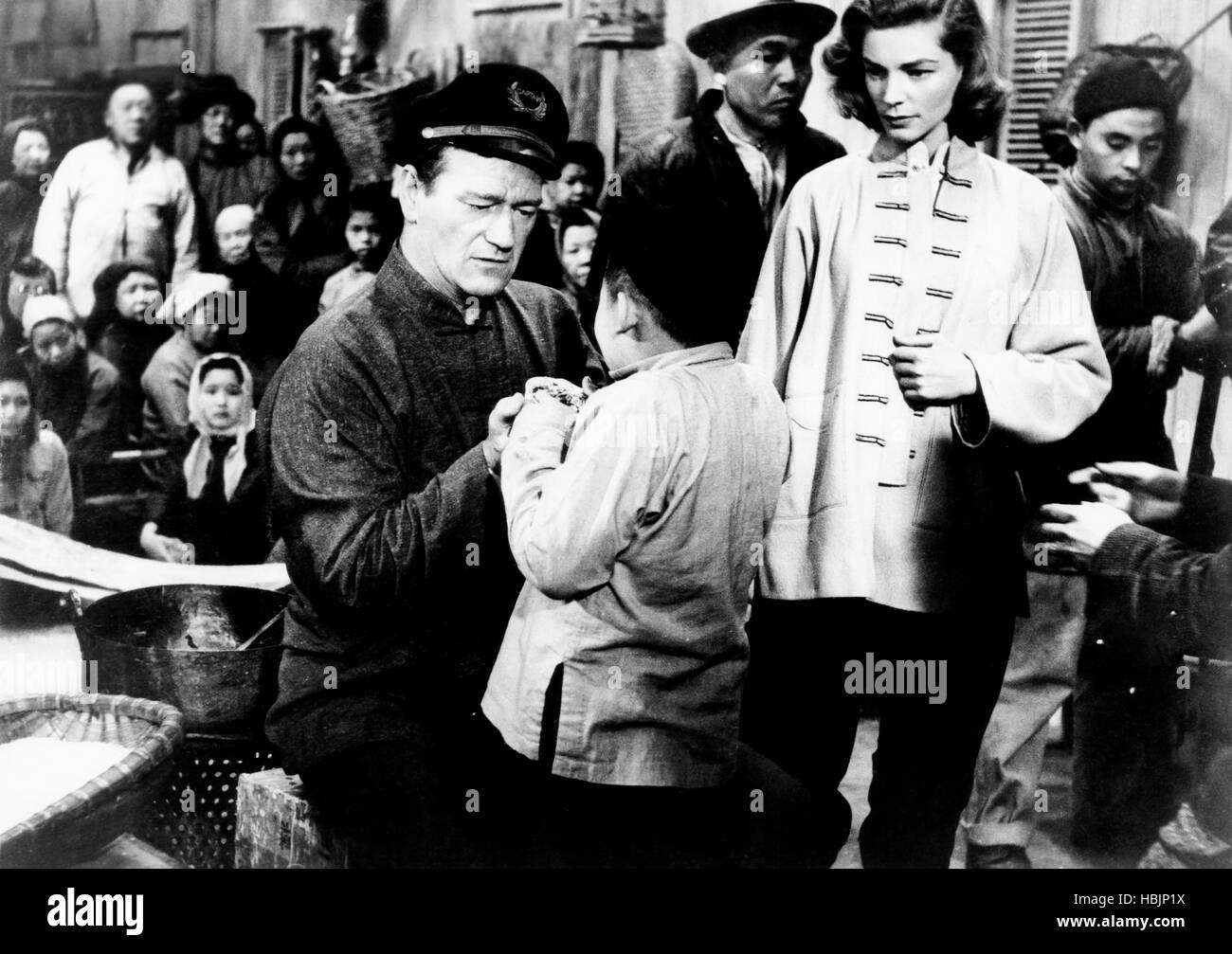 BLOOD ALLEY, front from left: John Wayne, Lauren Bacall, 1955 Stock ...