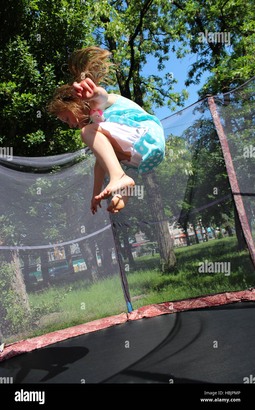 girl jumps on the trampoline Stock Photo - Alamy