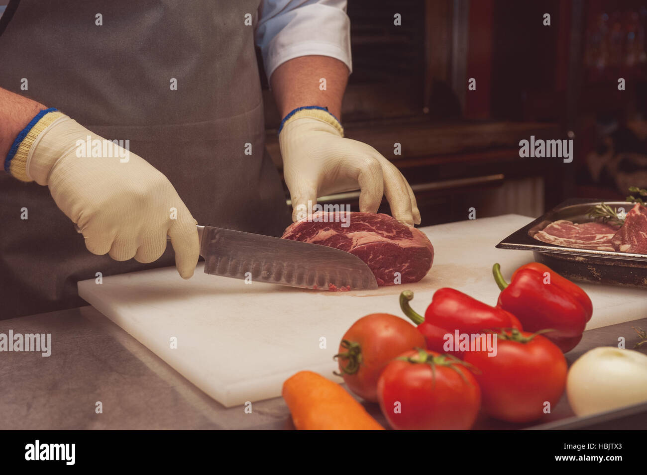 Chef cutting meat Stock Photo - Alamy