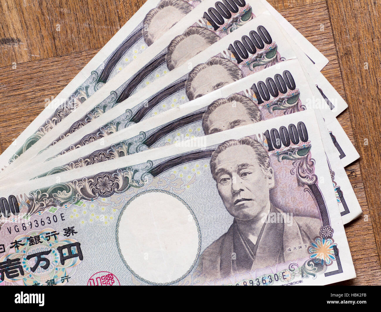Spreaded some Japanese 10000 yen bills on the wooden board Stock Photo ...