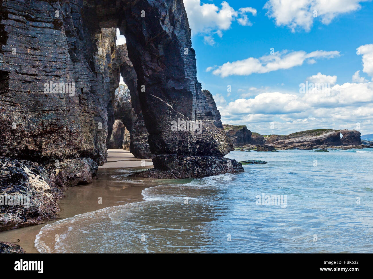 Natural arches on beach Stock Photo - Alamy