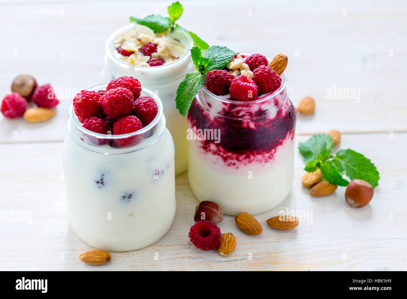 Jars with homemade yogurt, raspberries, nuts Stock Photo - Alamy
