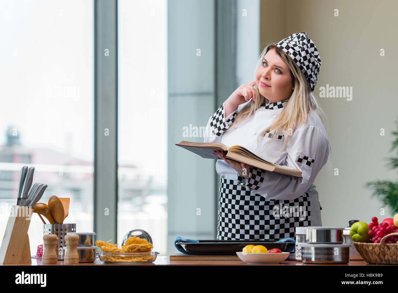 Young chef cook working in the kitchen Stock Photo - Alamy