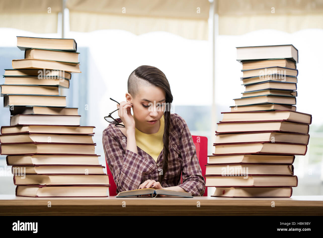 Young student with stack of books Stock Photo - Alamy