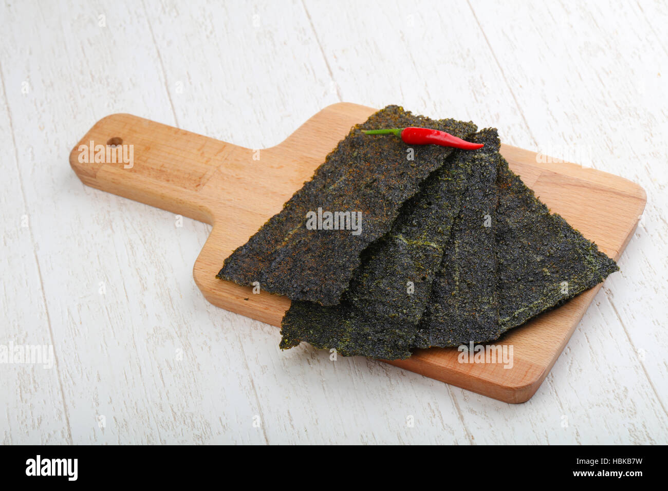 Spicy Nori seaweed sheets with pepper on wood Stock Photo - Alamy