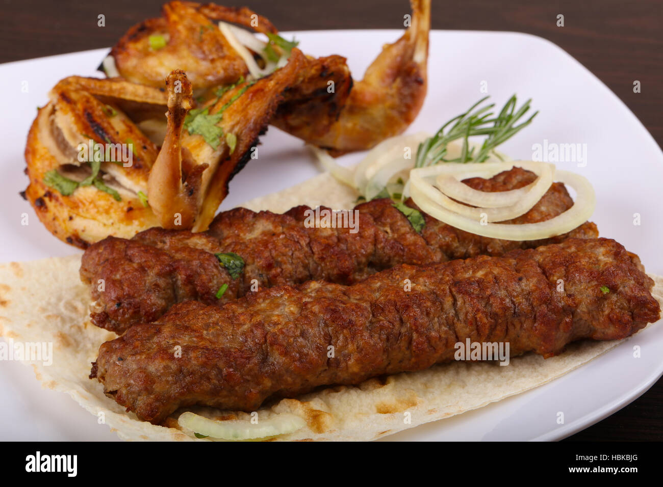 Beef kebab and grilled Quail with onion and parsley Stock Photo - Alamy