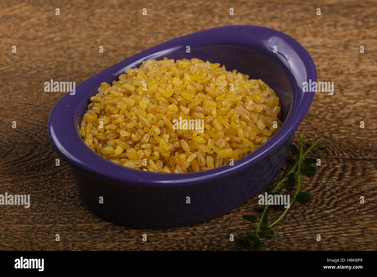 Raw bulgur heap in the bowl ready for cooking Stock Photo - Alamy