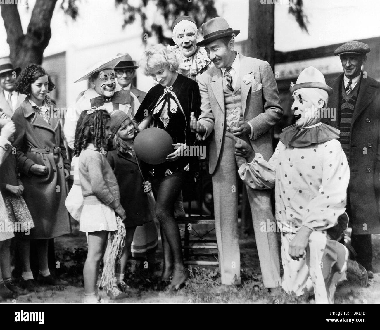 From center left: actors Greta Nissen (holding ball) and Adolphe Menjou ...