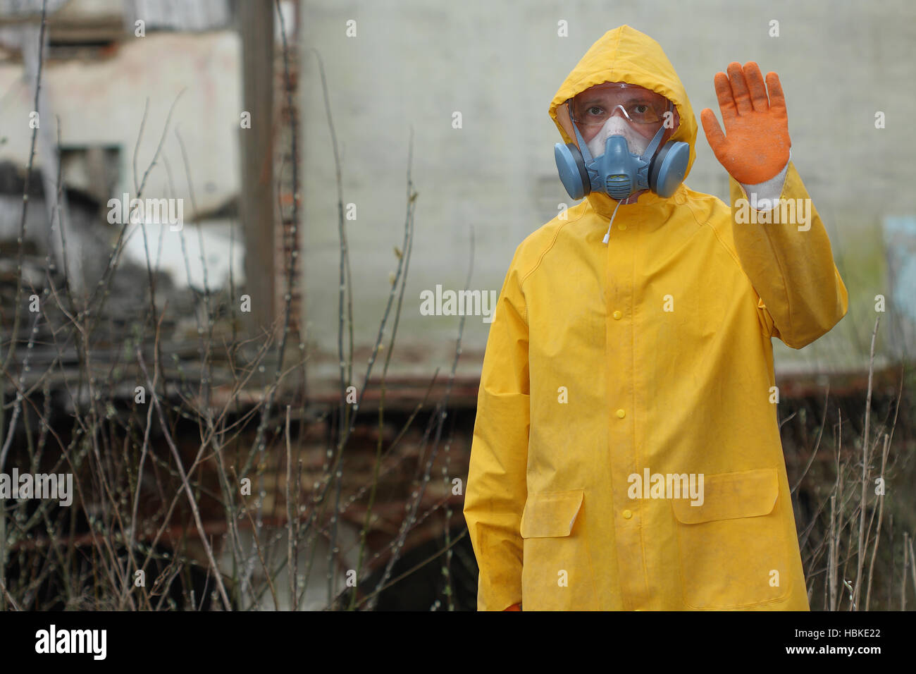 Man with protective mask and protective clothes explores danger area ...