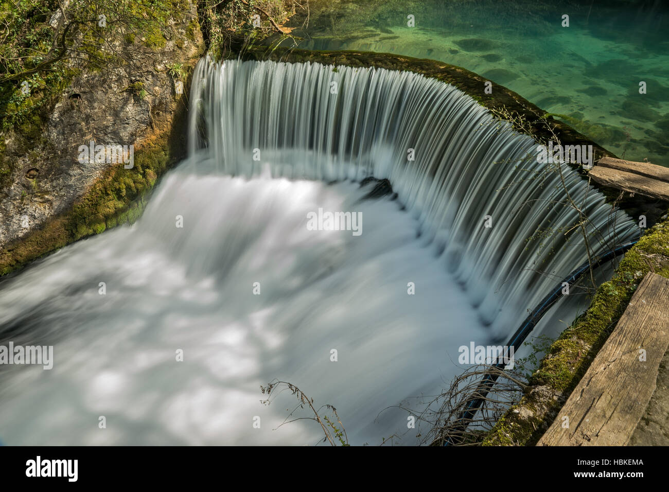 Semicircular dam with small lake that cause waterfall on river Rasina ...