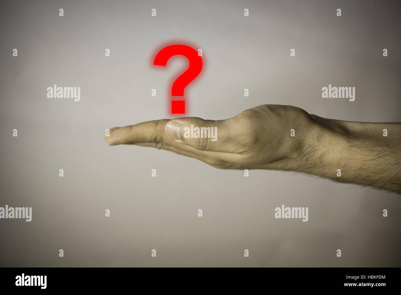 Human hand on vintage background with question mark Stock Photo - Alamy