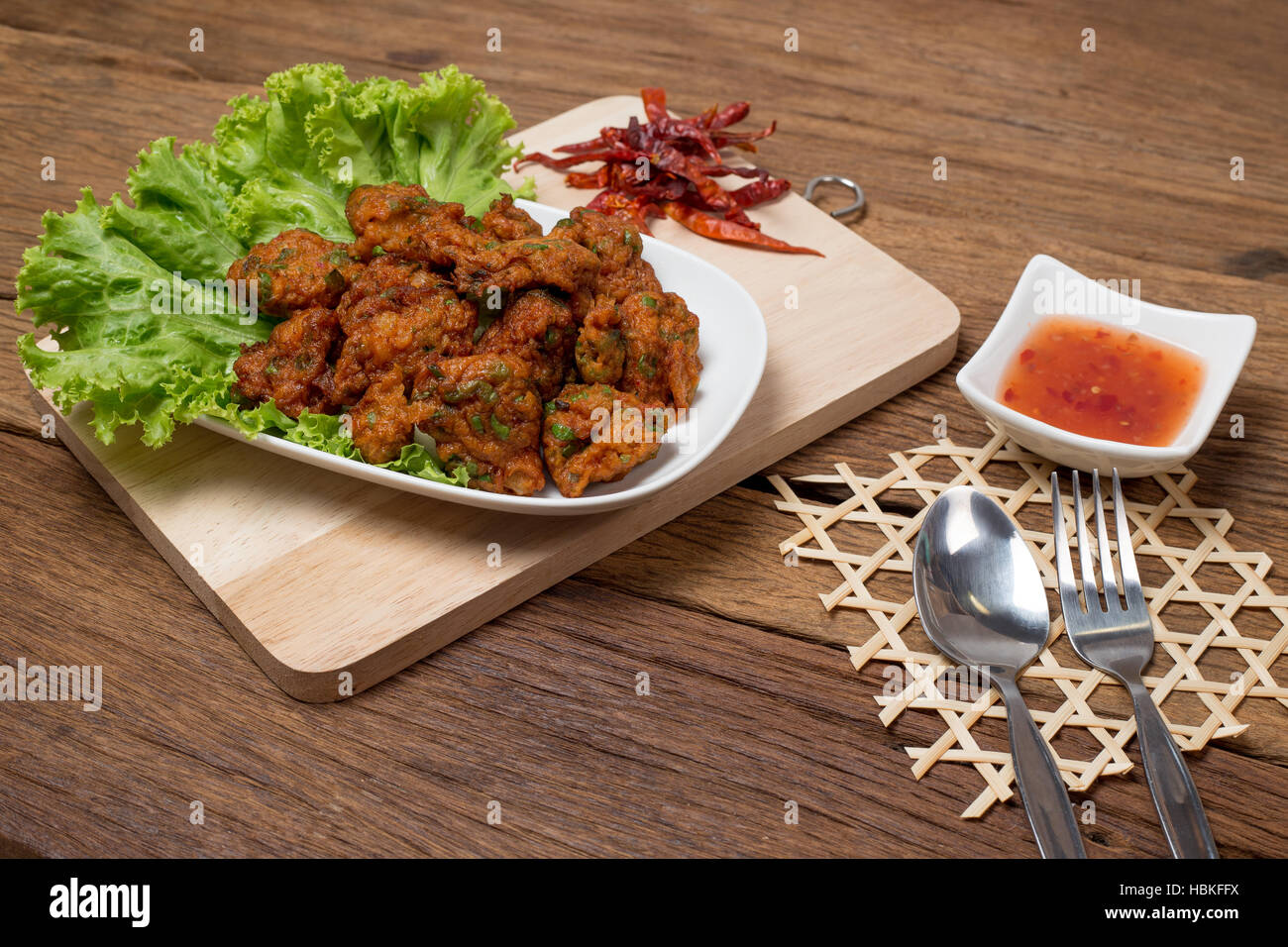 Thai fried fish cake (Tod Mun Pla) or prawn fritter ball with dipping ...