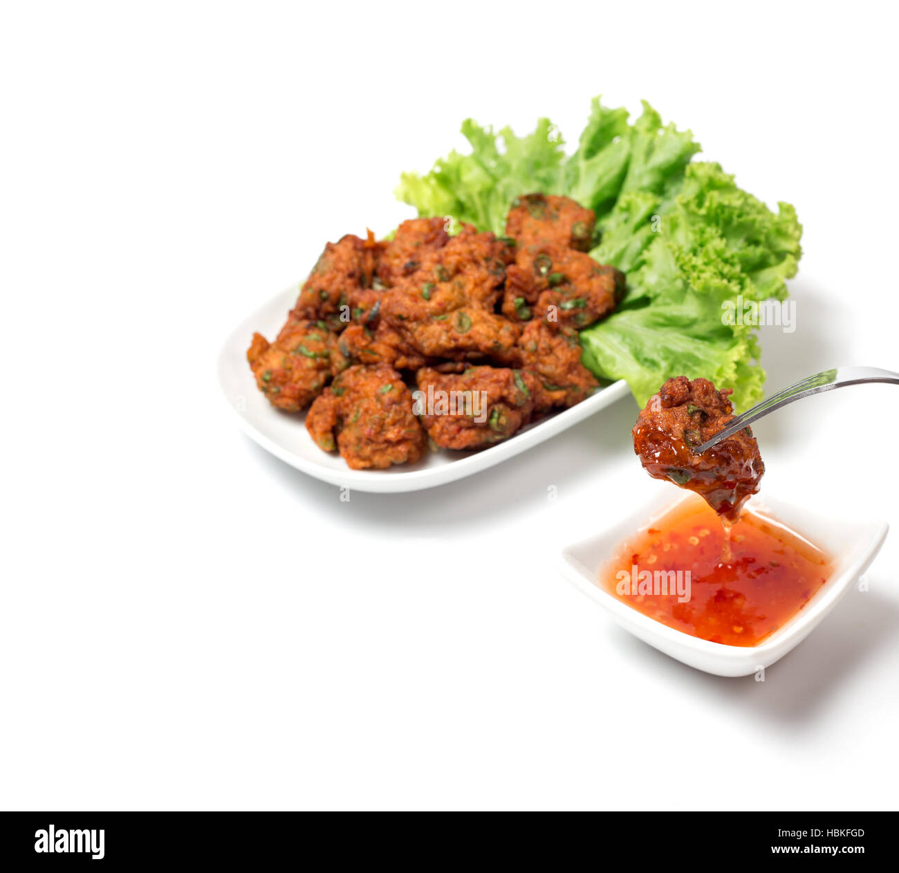 Thai fried fish cake (Tod Mun Pla) or prawn fritter ball serve with red ...