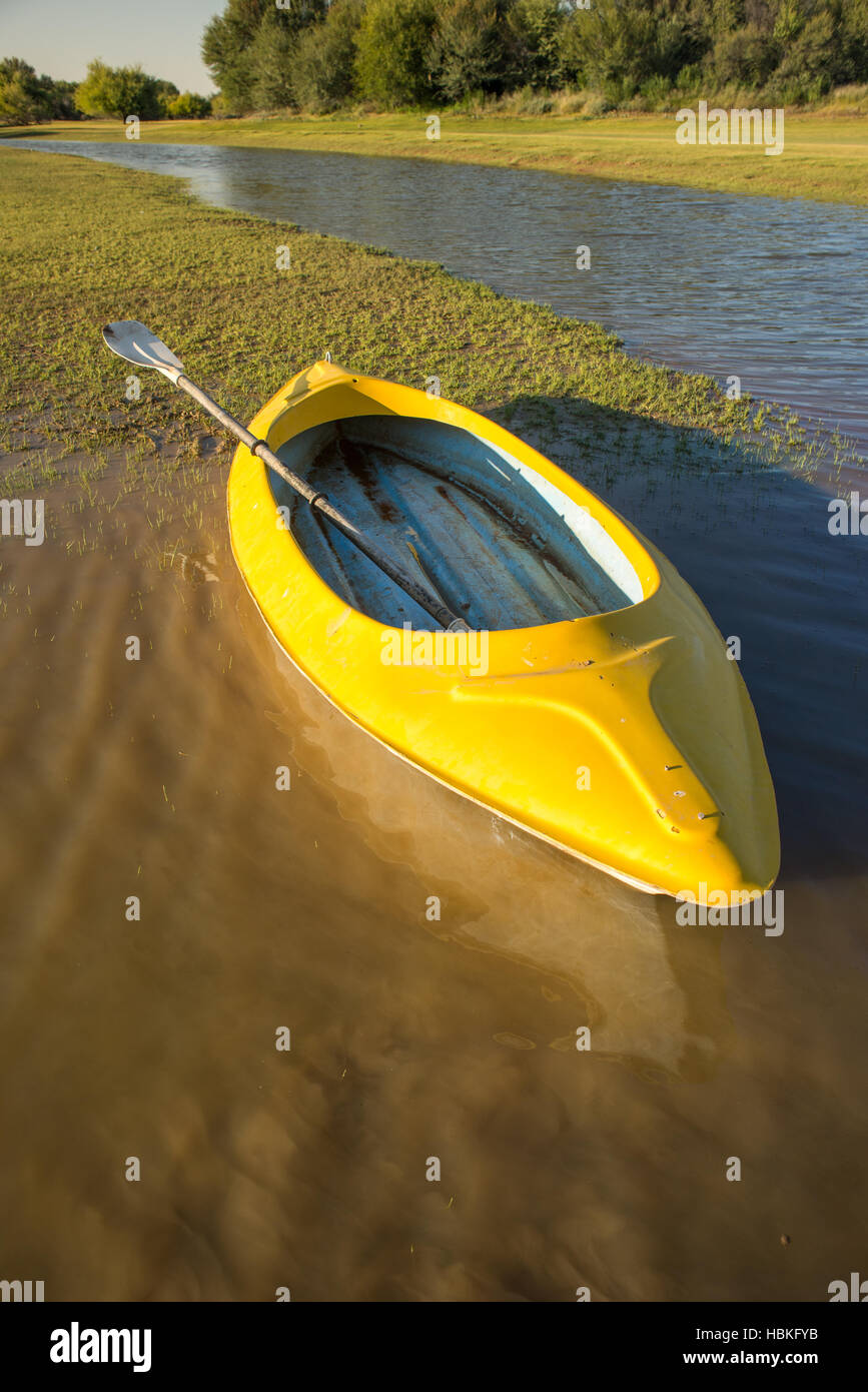 Yellow kayak by water Stock Photo - Alamy