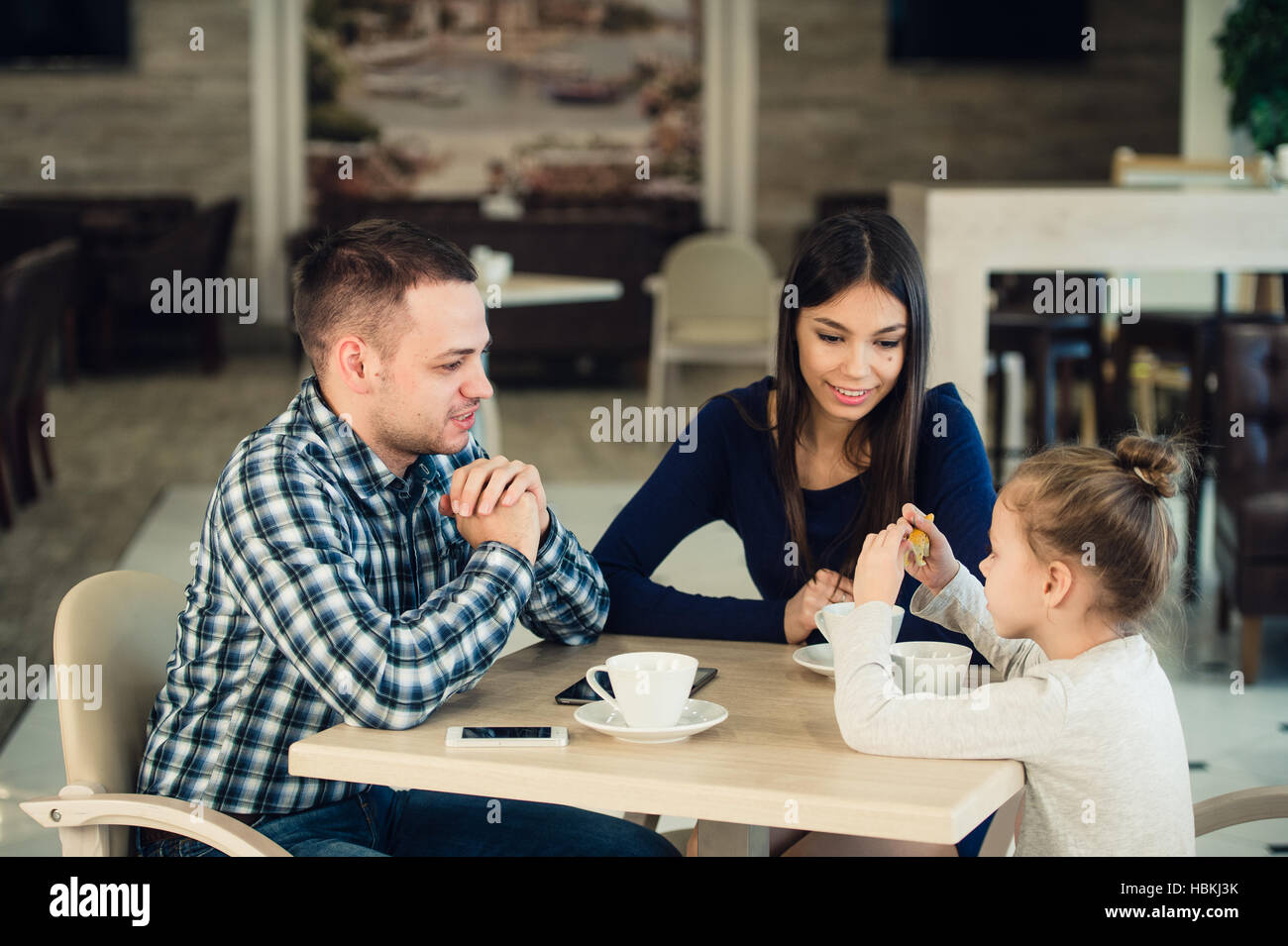 Family Enjoying tea In Cafe Together Stock Photo - Alamy