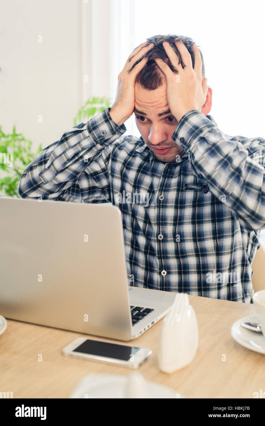 Closeup portrait, stressed young man, shocked surprised, horrified and disturbed, by what he ...