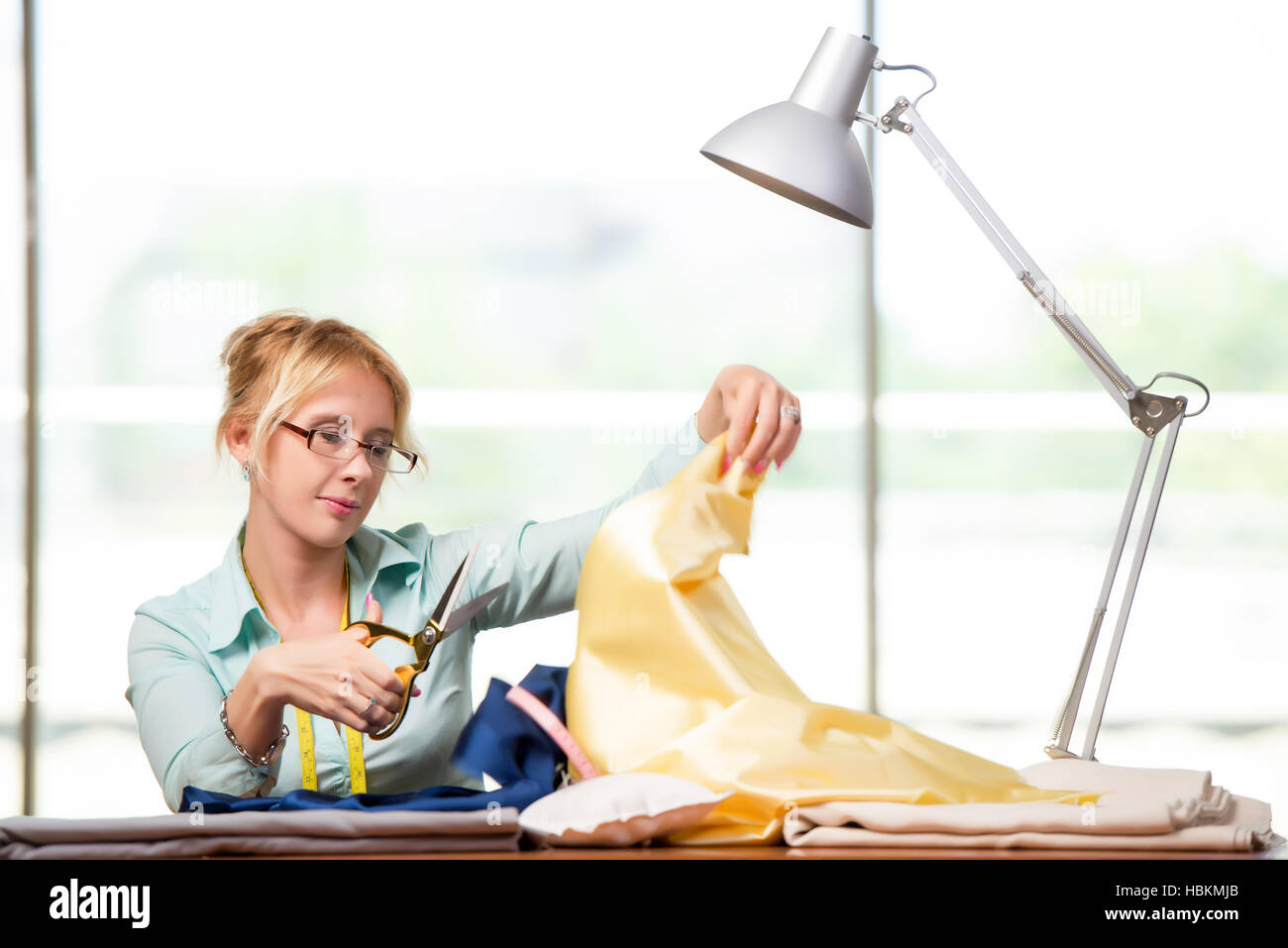 Woman tailor working on new clothing Stock Photo - Alamy