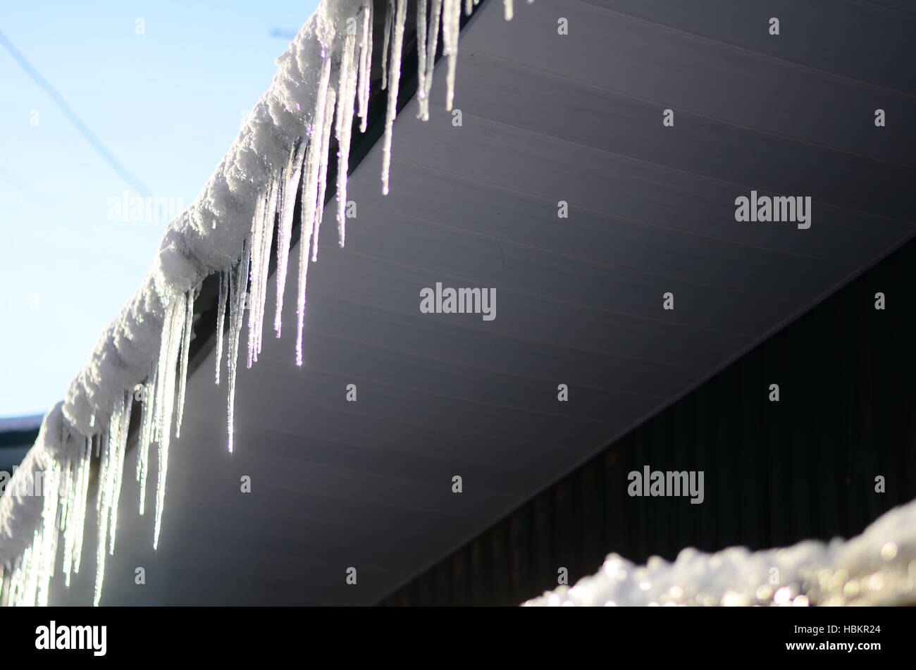 icicles which are hanging down from a roof Stock Photo - Alamy