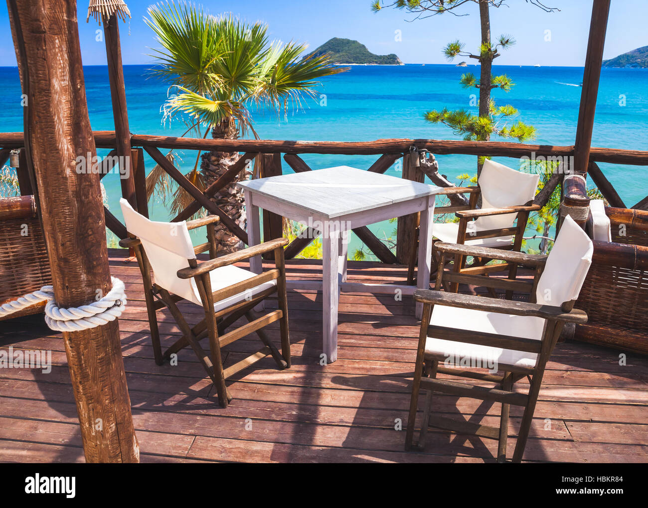 Seaside balcony with wooden furniture, popular touristic resort island ...