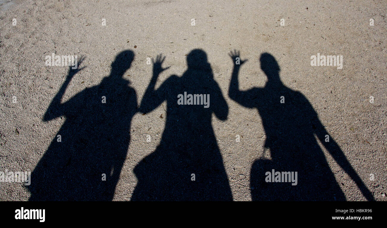 Shadows of three friends Stock Photo - Alamy