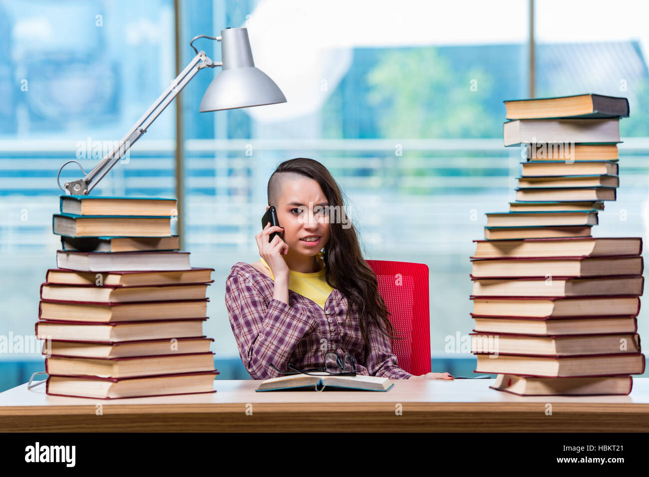 Young female student talking on mobile phone Stock Photo - Alamy