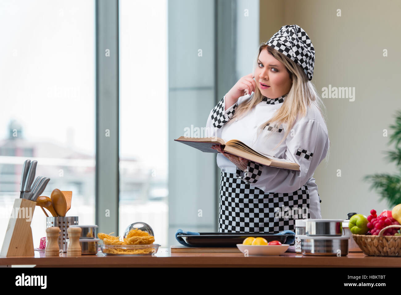 Young chef cook working in the kitchen Stock Photo - Alamy