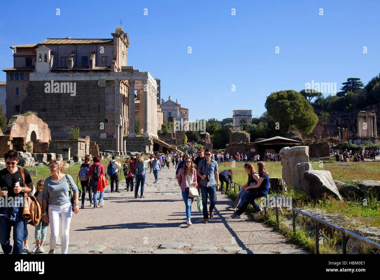 Rome, Roman Forum with tourists, pillars of the Temple of Antoninus and ...