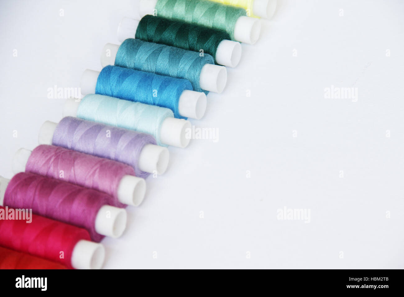 Sewing colored threads Stock Photo - Alamy