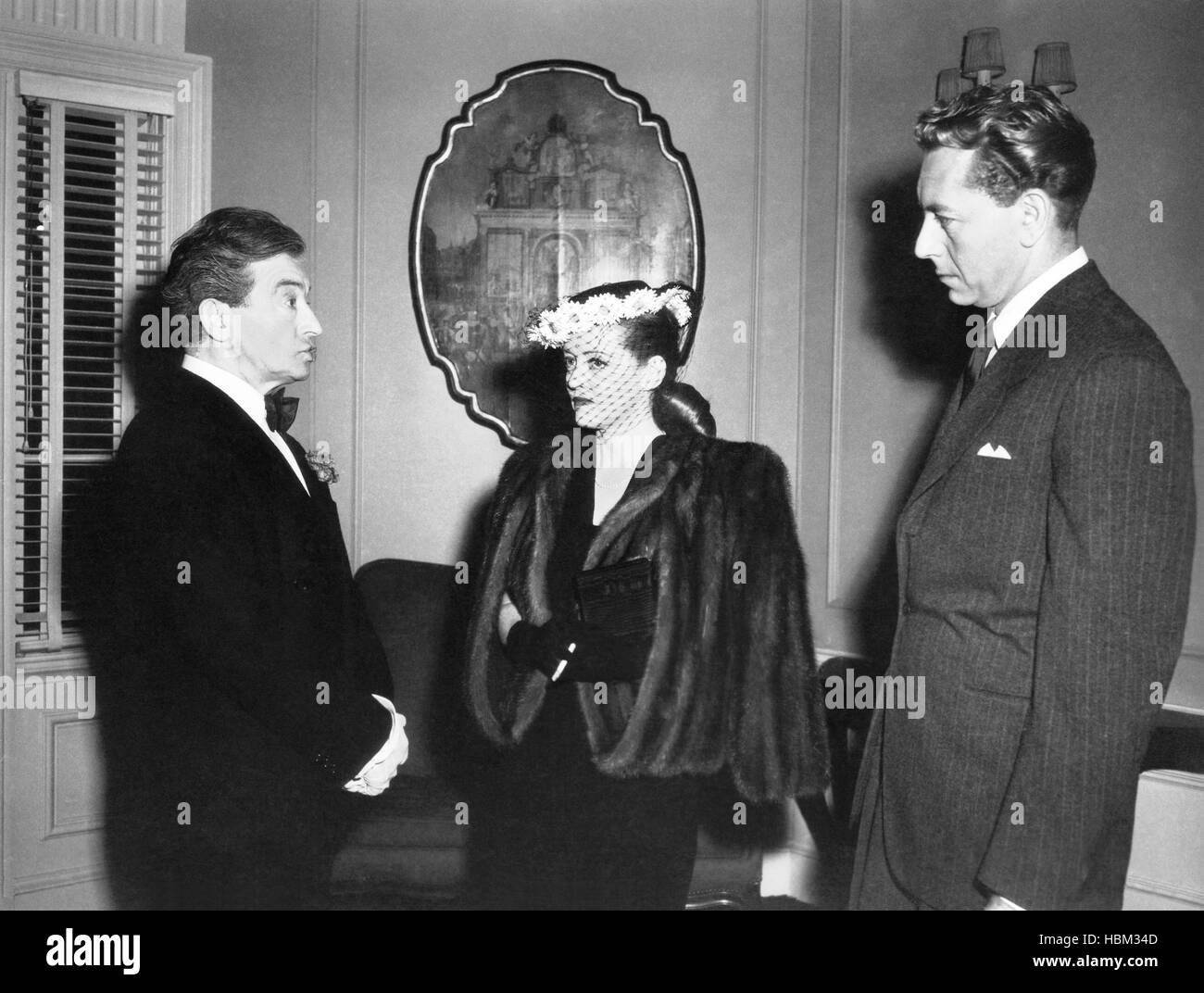 DECEPTION, from left: Claude Rains, Bette Davis, Paul Henreid, on set ...