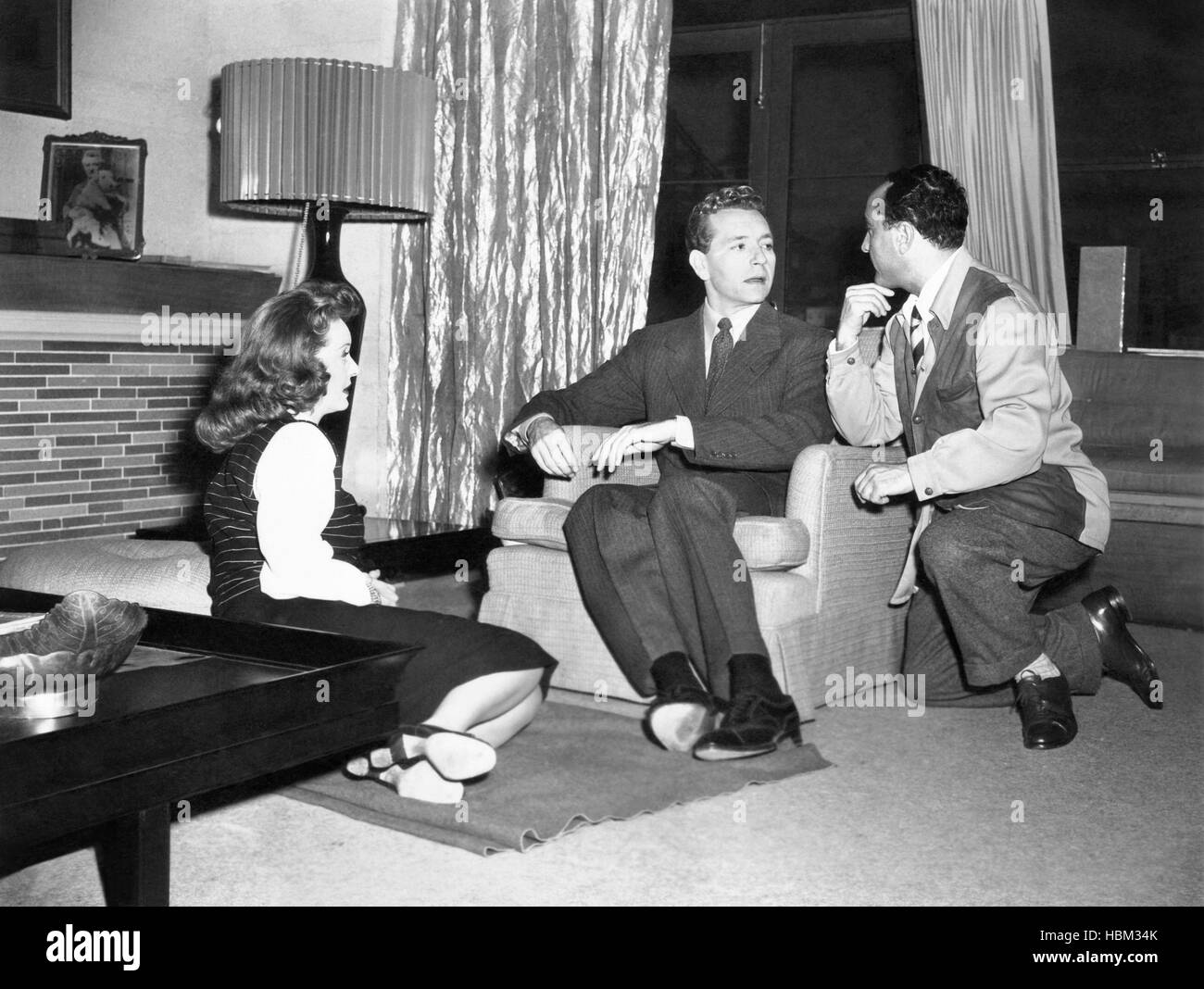 DECEPTION, from left: Bette Davis, Paul Henreid, director Irving Rapper ...