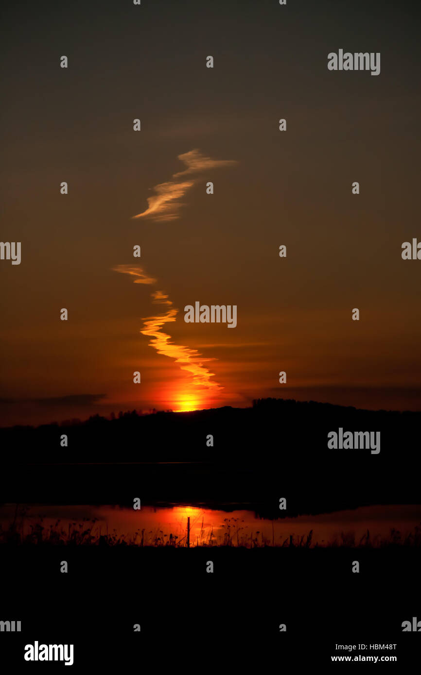 Beautiful line of clouds on a summer sunset background reflected in ...