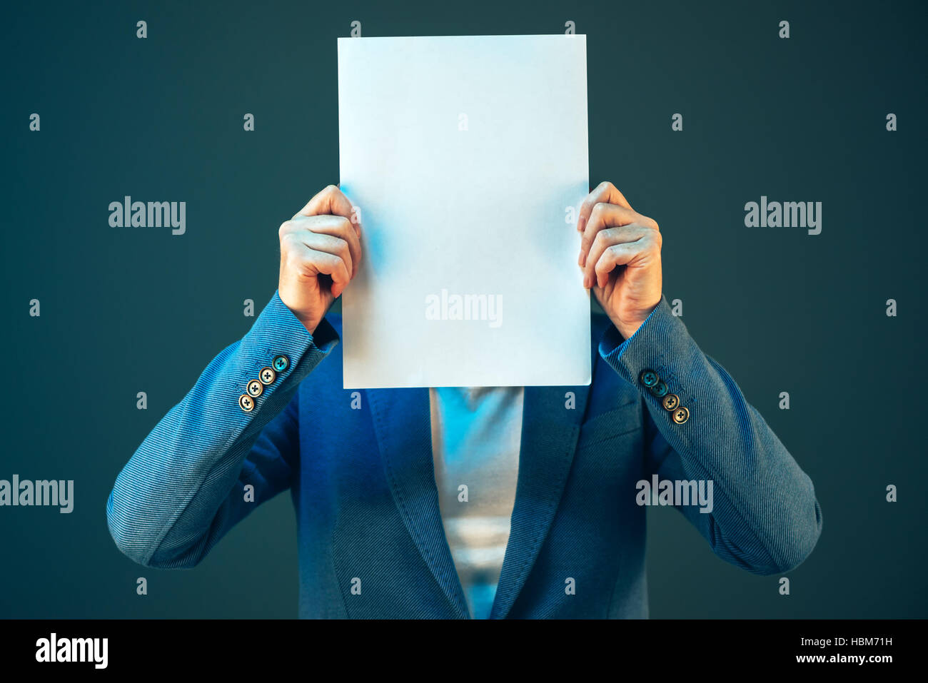 Blank business document paper covering businesswoman's face, copy space ...