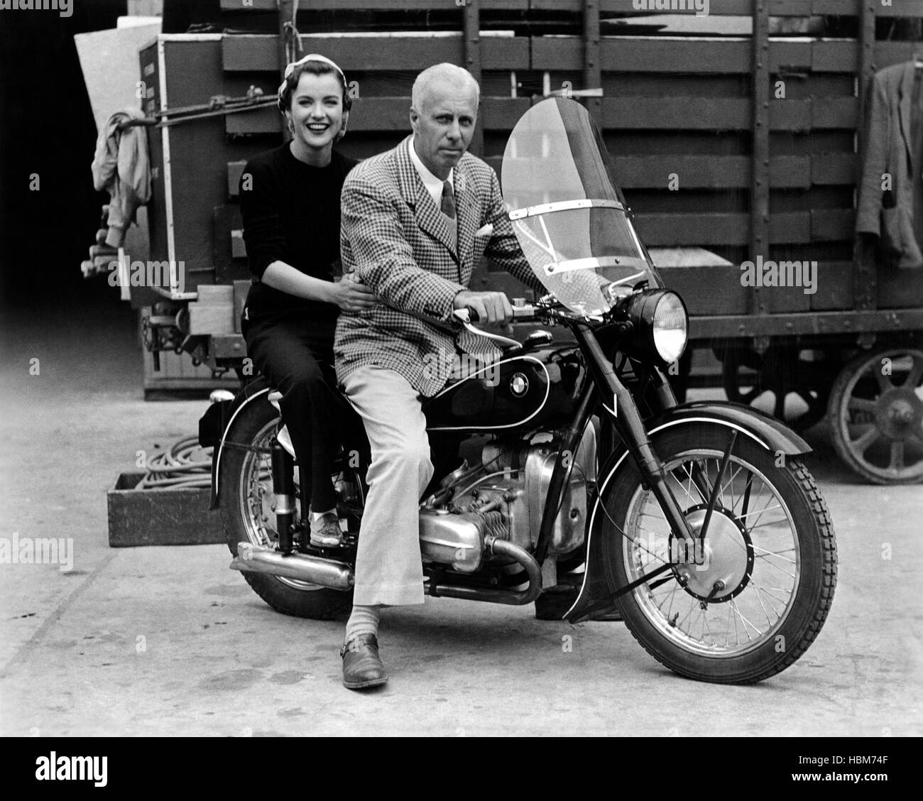 CORVETTE K-225, Ella Raines and Howard Hawks ride a motorcycle on set ...