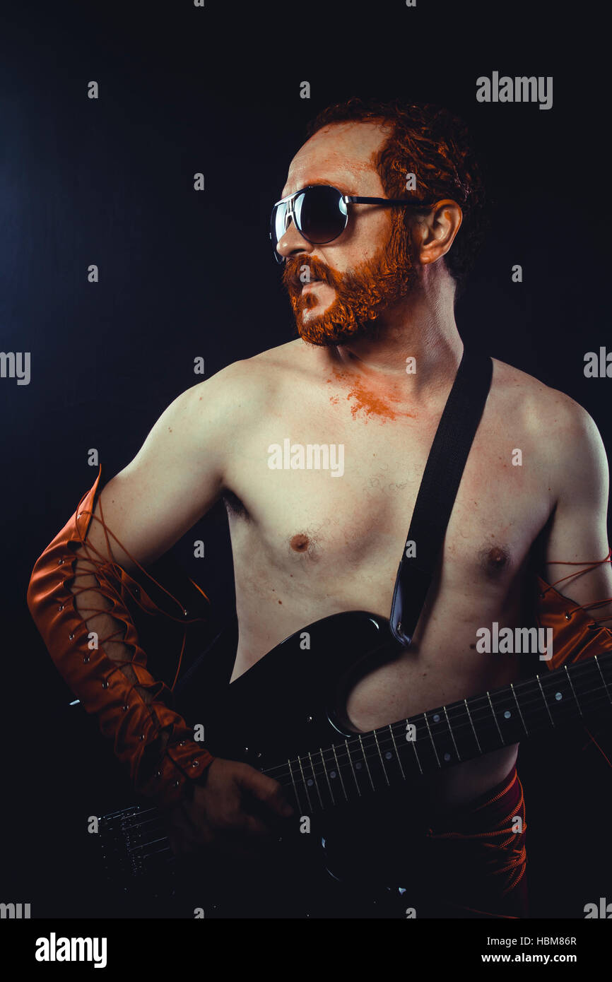 Rock star with electric guitar and concert hall smoke environment Stock ...