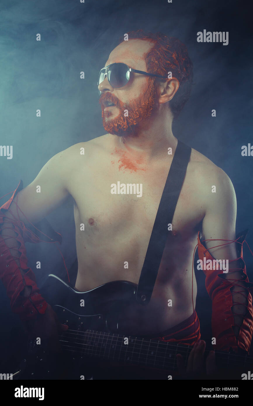 Entertainment, Rock star with electric guitar and concert hall smoke ...