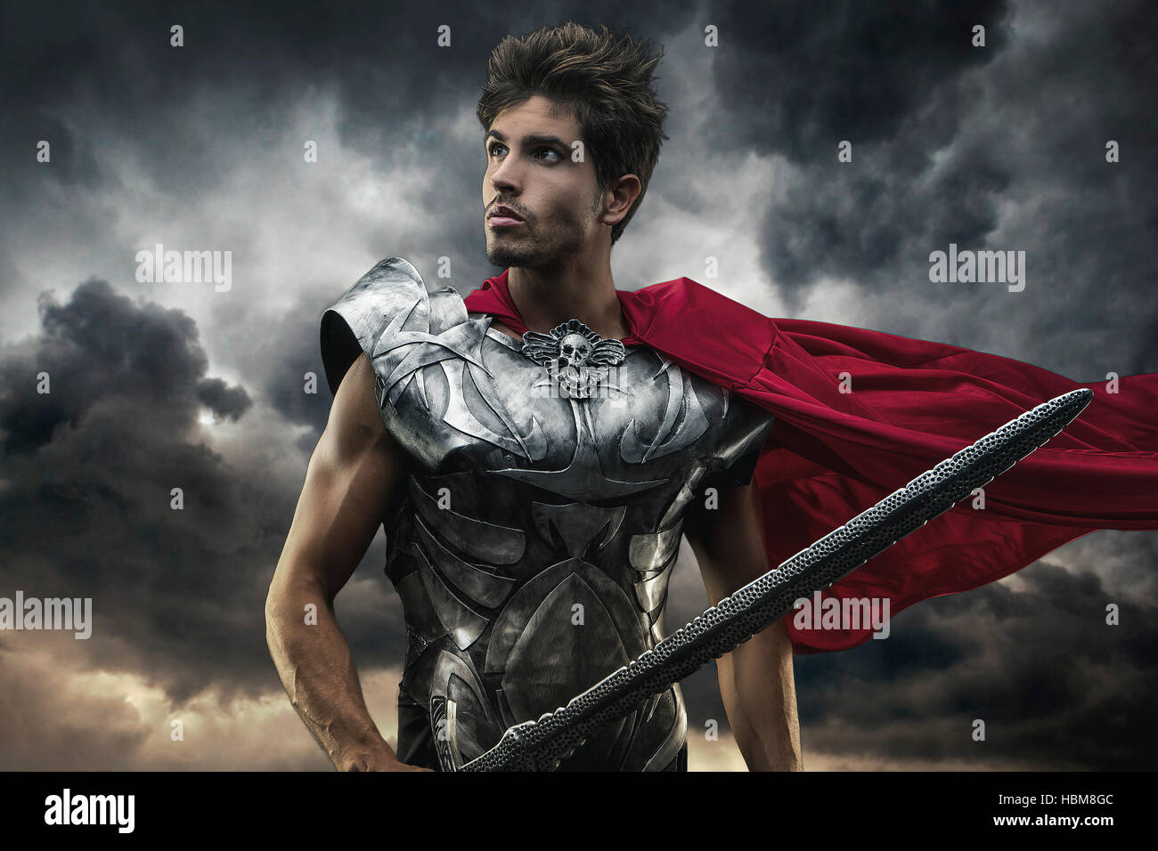 Roman Emperor with red cape and armor looking at the horizon before the ...