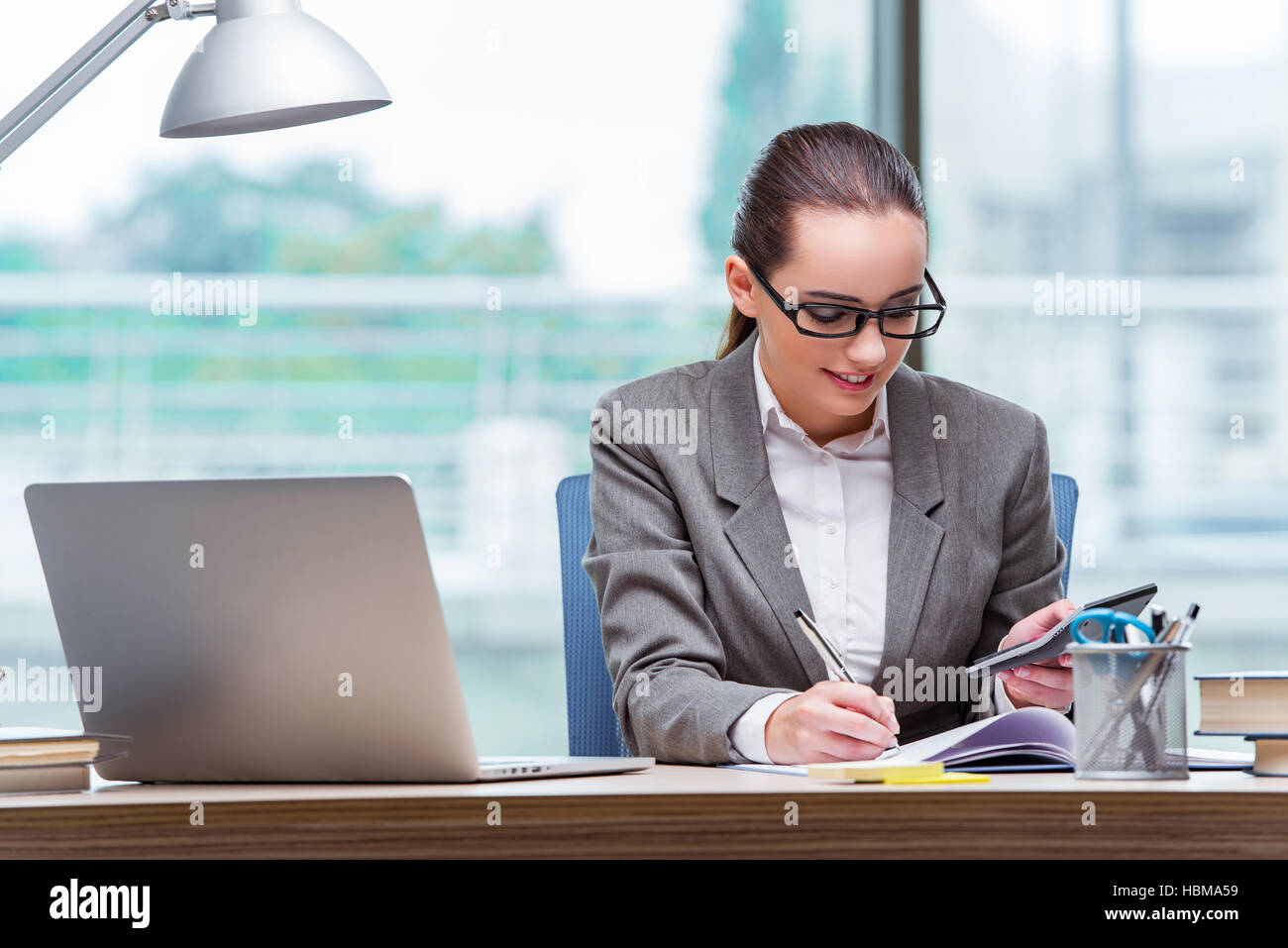 Young assistant working in the office Stock Photo - Alamy