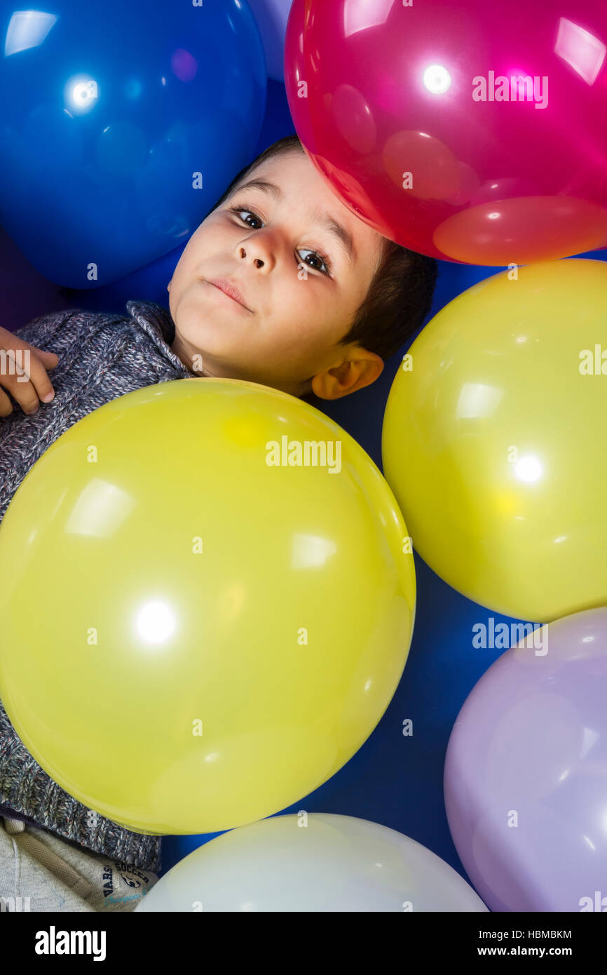 child playing with colored balloons at a birthday party happy Stock ...