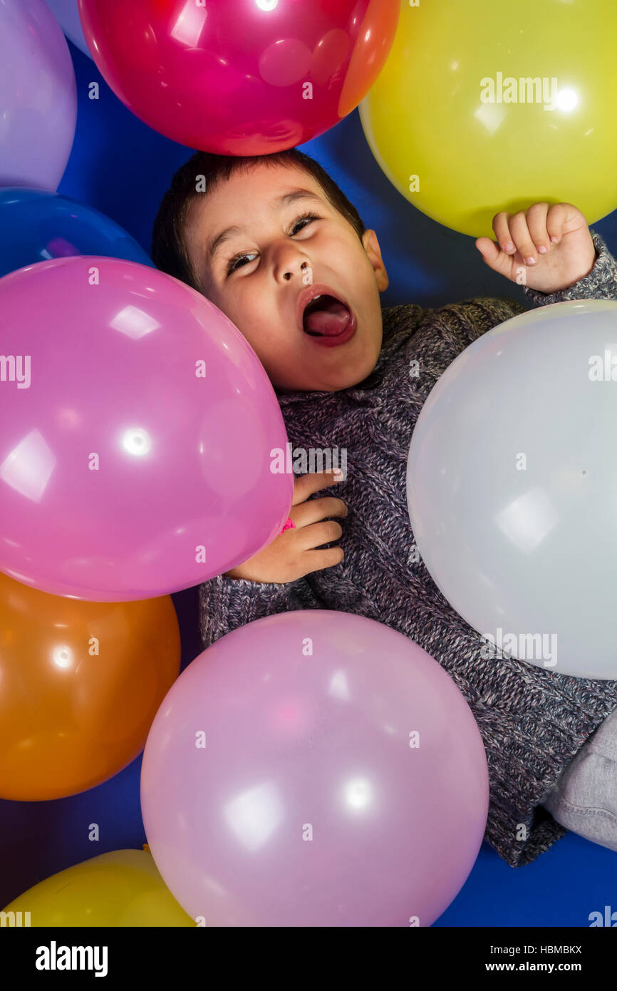fun child playing with colored balloons at a birthday party happy Stock ...