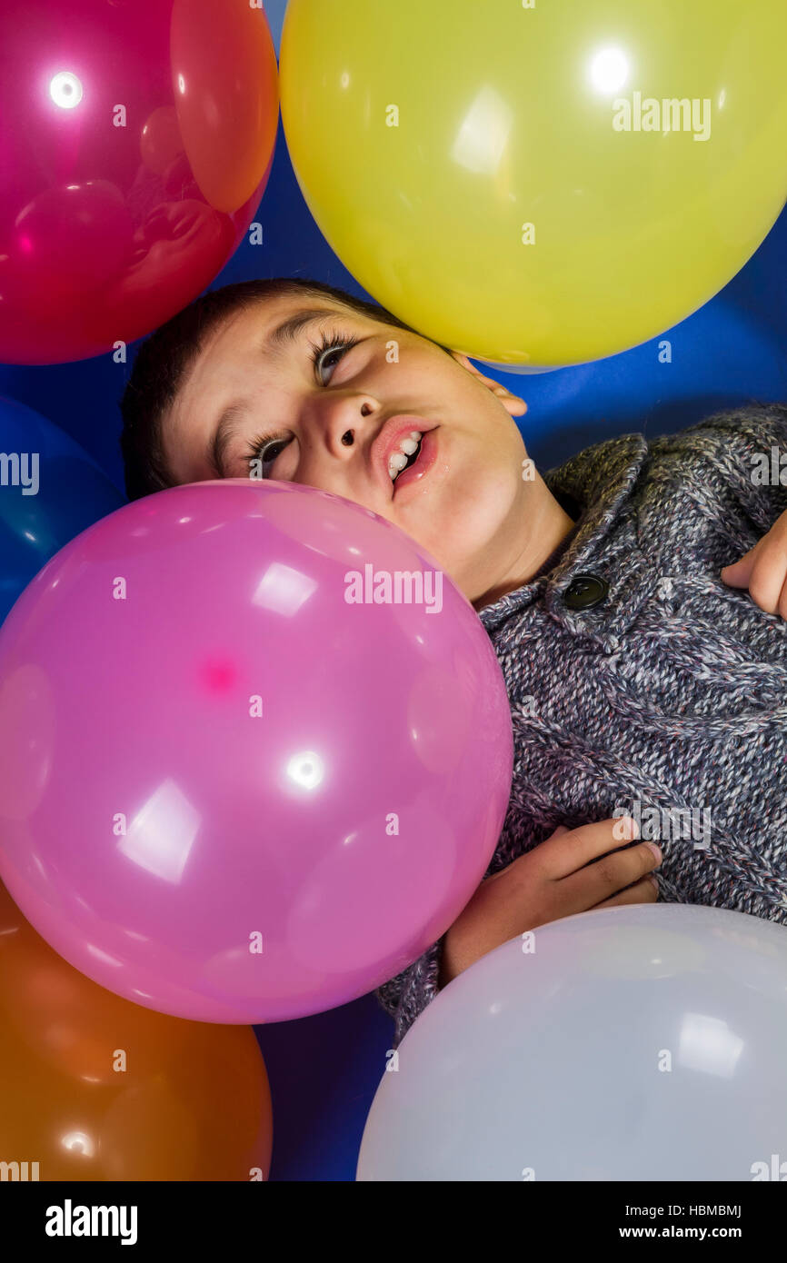 child playing with colored balloons at a birthday party happy Stock ...