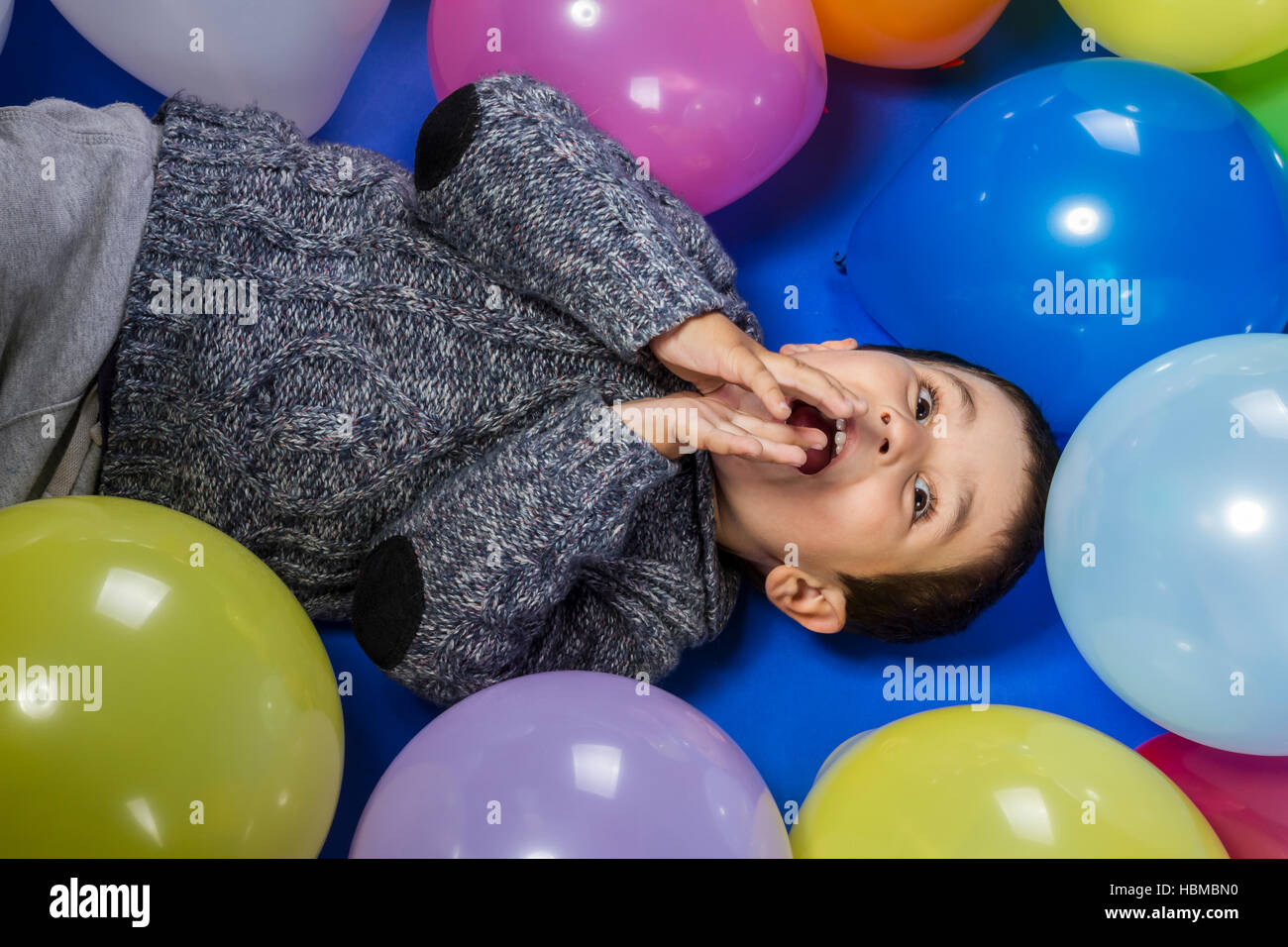 Celebration child playing with colored balloons at a birthday party ...
