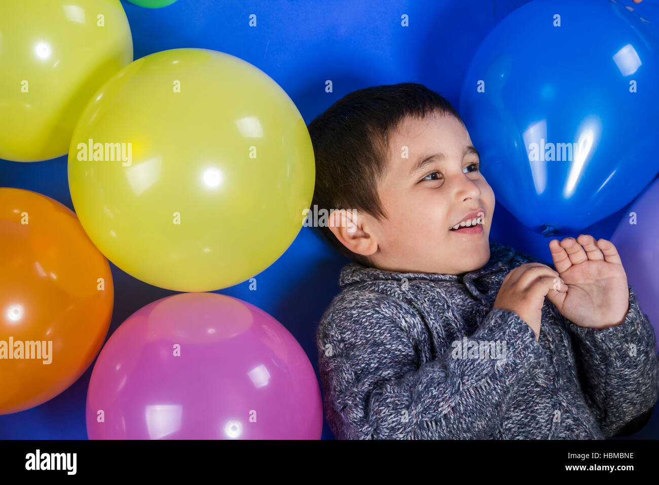 child playing with colored balloons at a birthday party happy Stock ...